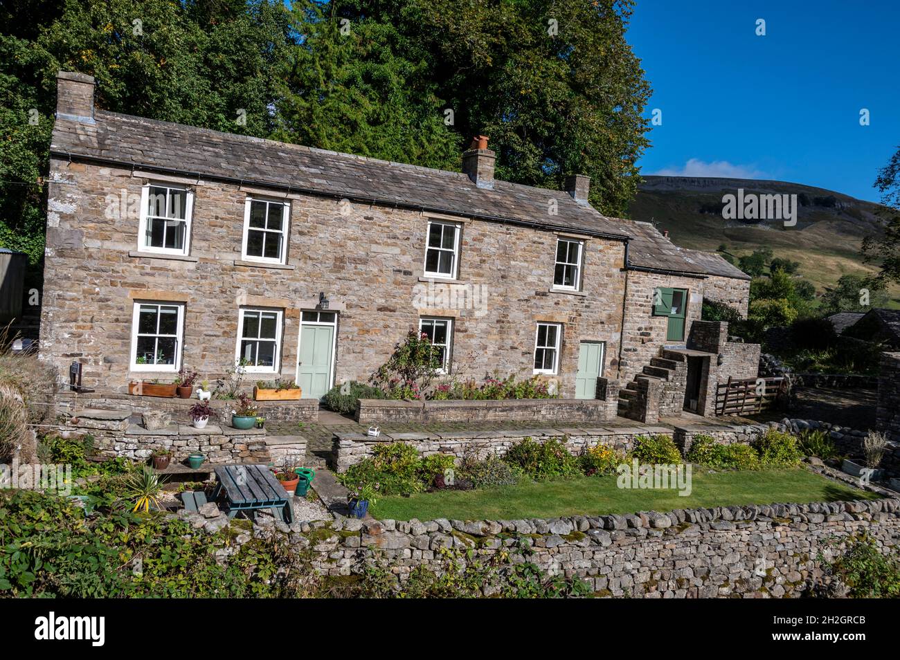 Traditional Yorkshire grey stone-built houses in the village of Muker ...