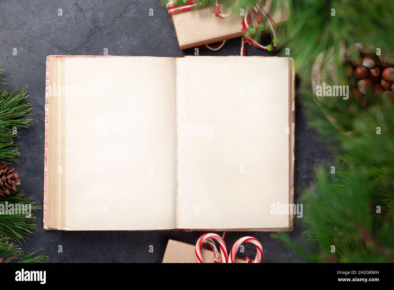 Christmas gift box with craft decor and vintage book. Top view flat lay ...
