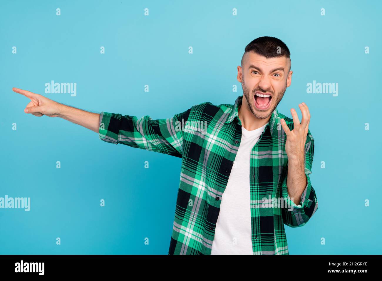 Photo of unhappy upset young angry man point finger empty space scream ...