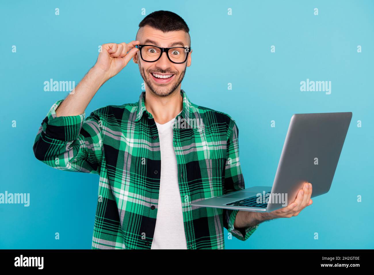 Photo of cheerful happy amazed man hold hands laptop programmer wear ...