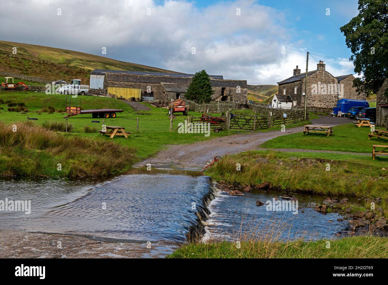 A rural farm, ‘Ravenseat’ beside the flowing Whitsundale Beck in ...