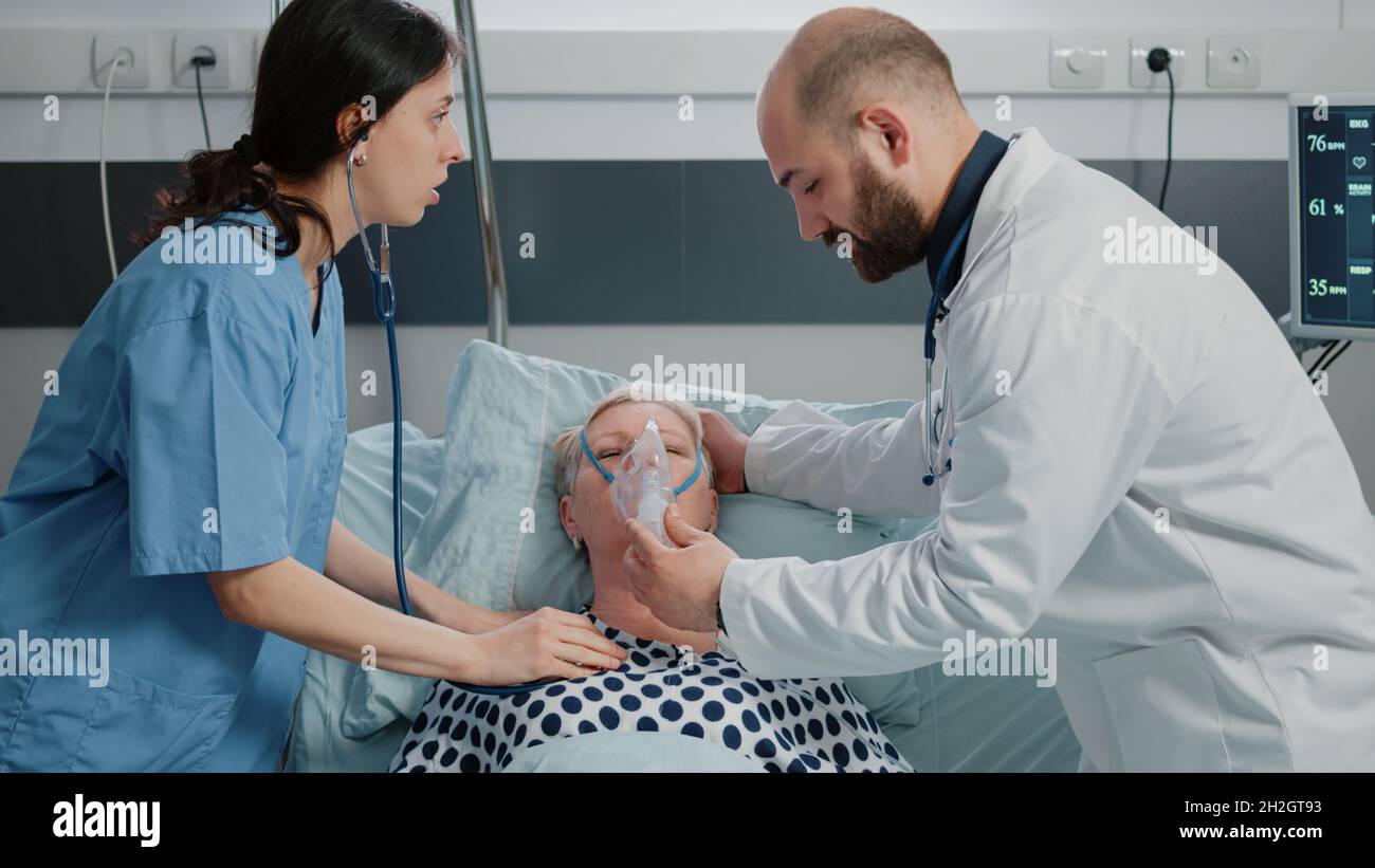 Doctor using oxygen tube mask for ill patient hyperventilating in ...