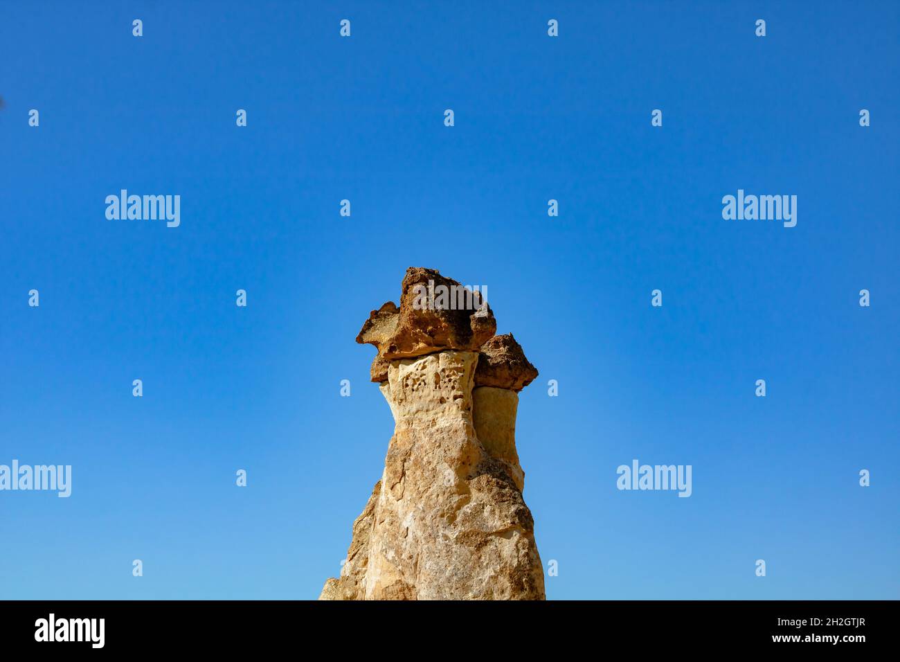 A fairy chimneys or peri bacasi on clear sky background in Cappadocia ...