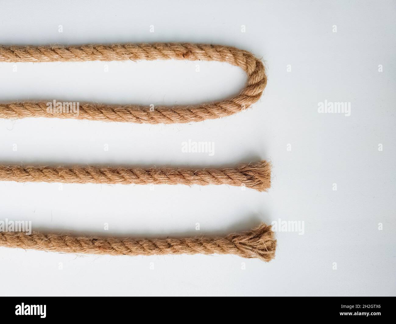 Rough natural rope strings pieces on white background Stock Photo - Alamy