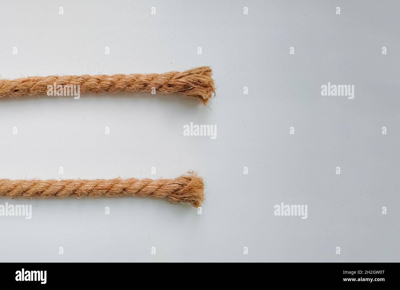Rough natural rope strings pieces on white background Stock Photo - Alamy