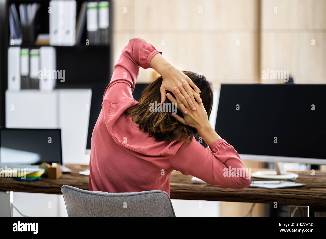 Business Woman Doing Stretch Exercise At Office Desk Stock Photo - Alamy