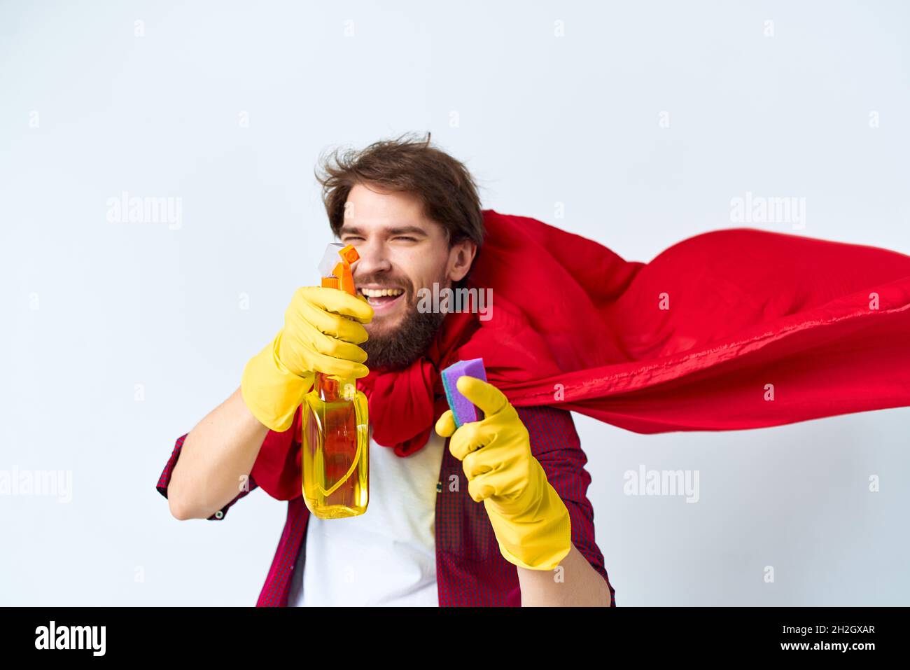 A man sitting on the floor red cloak cleaning the apartment ...