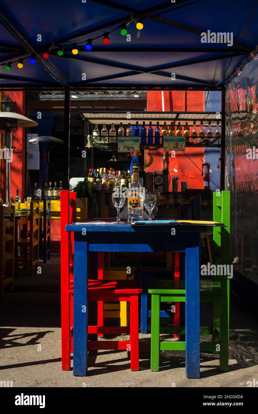 Vertical close-up view of one of the tables of a colorful bar terrace ...