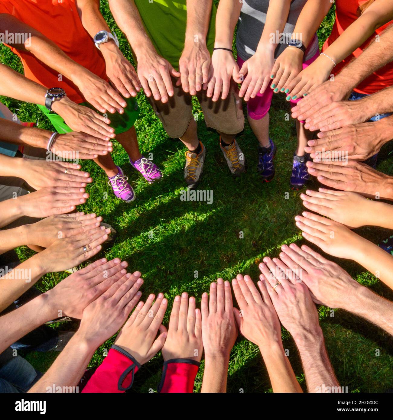 A group of people demonstrating their connectedness during a ...