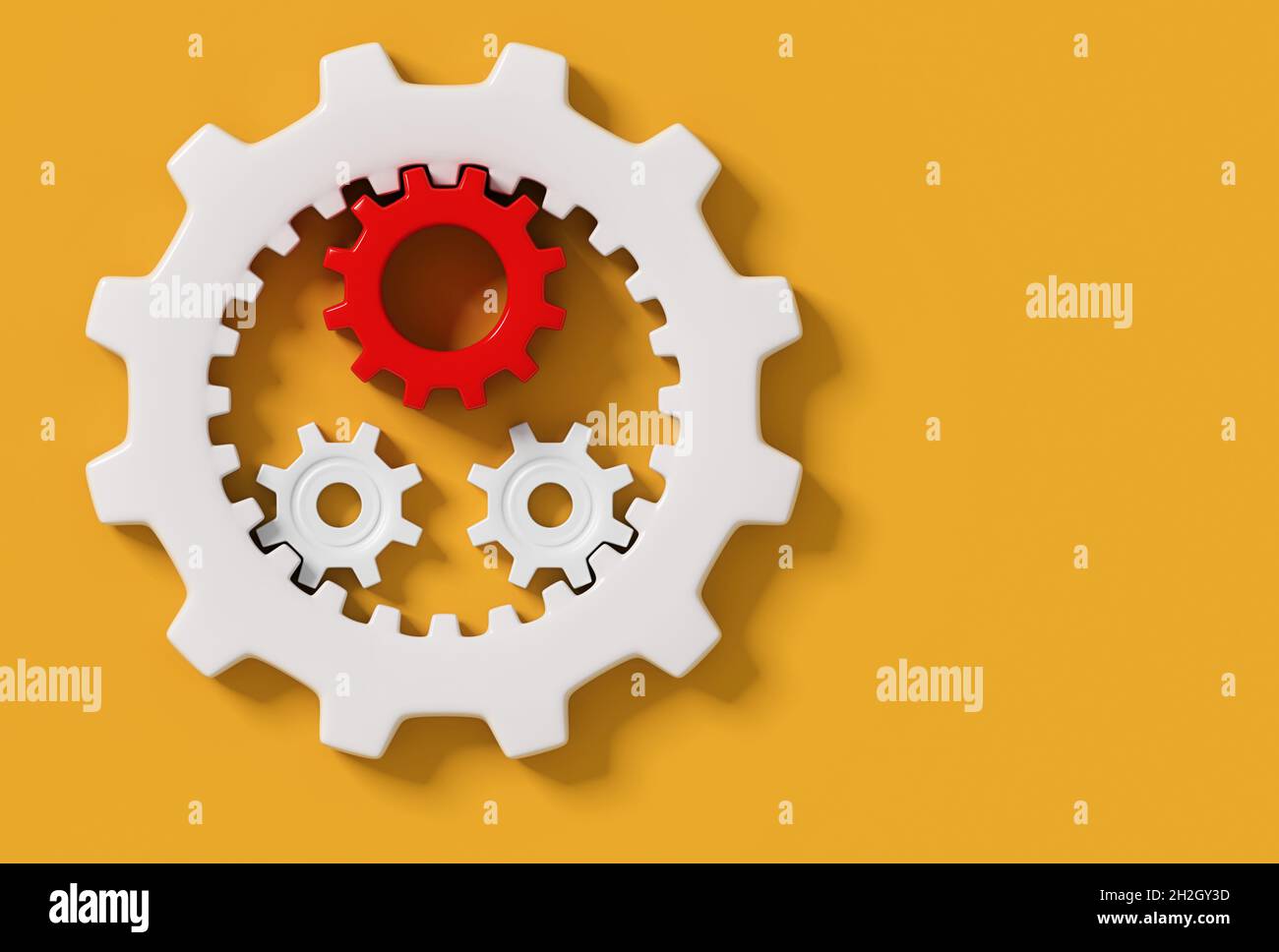 Small red and white connecting gear cogs inside big white cog isolated ...