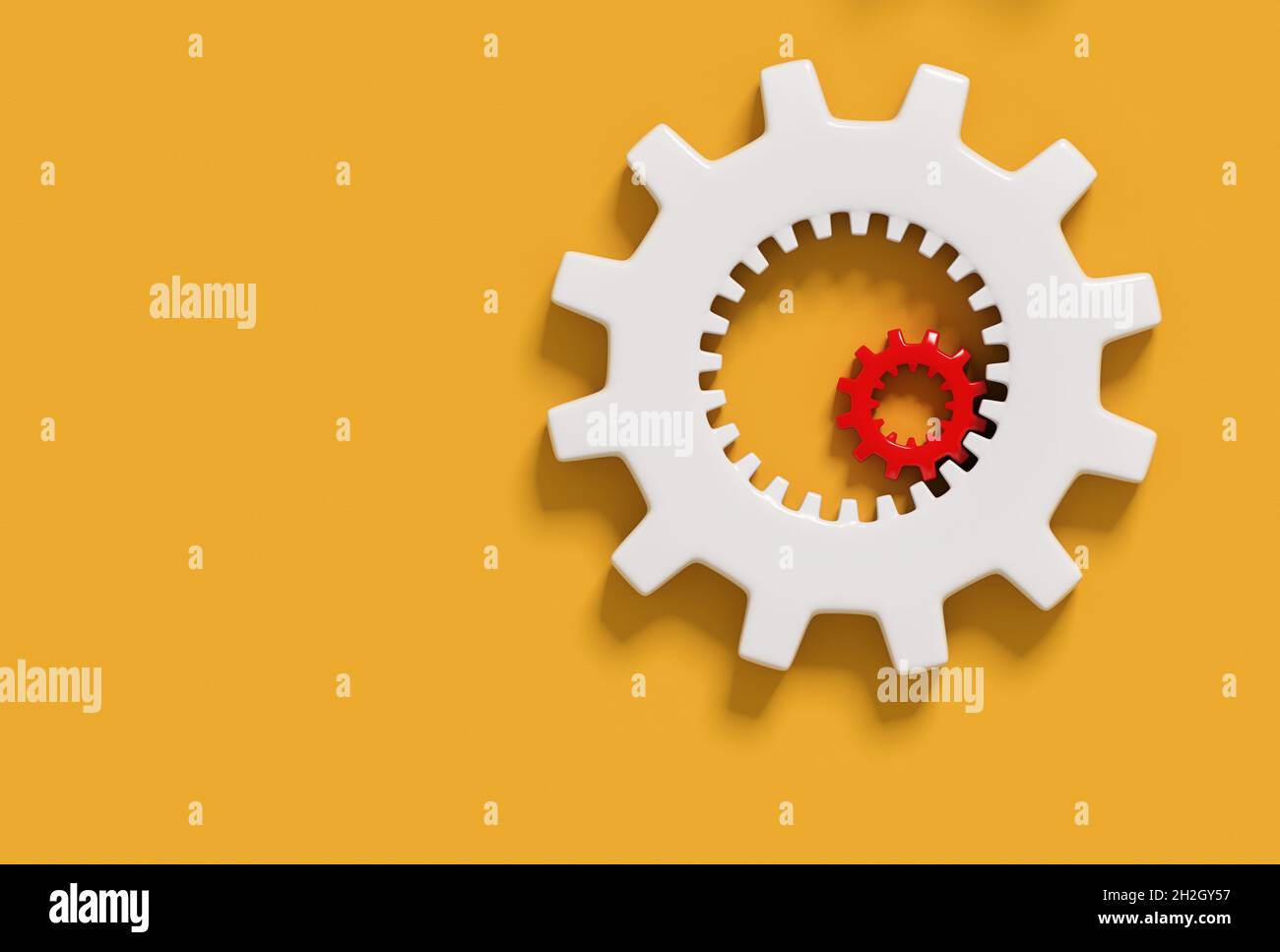 Small red connecting gear cog inside big white cog isolated on yellow ...