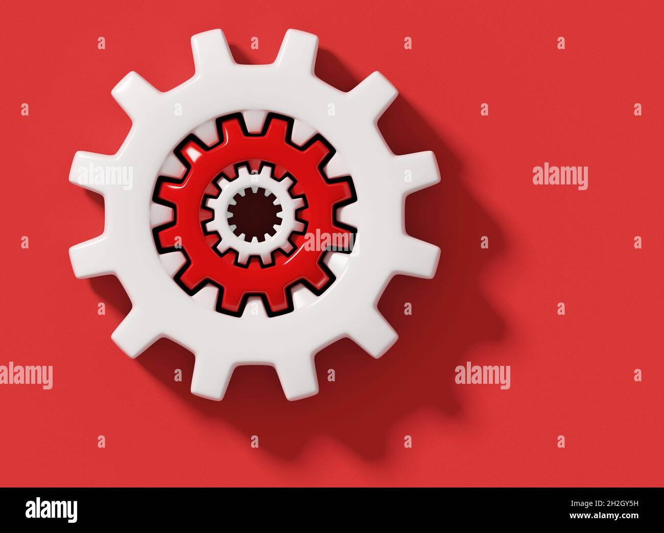White and red connecting gear cogs inside each other isolated on red ...