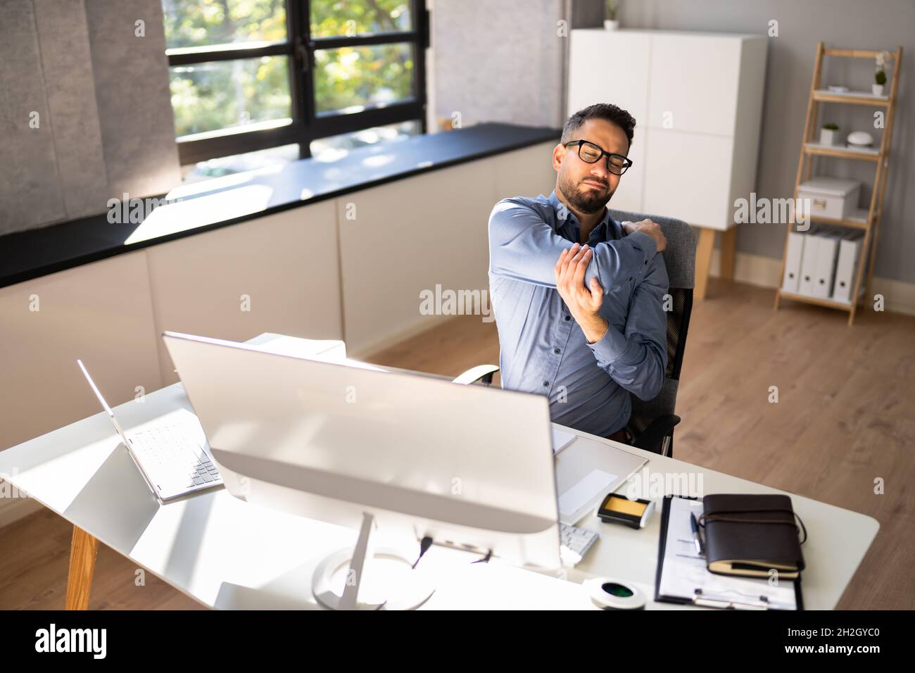 Shoulder Pain And Posture. Man Suffering Near Workstation Computer ...