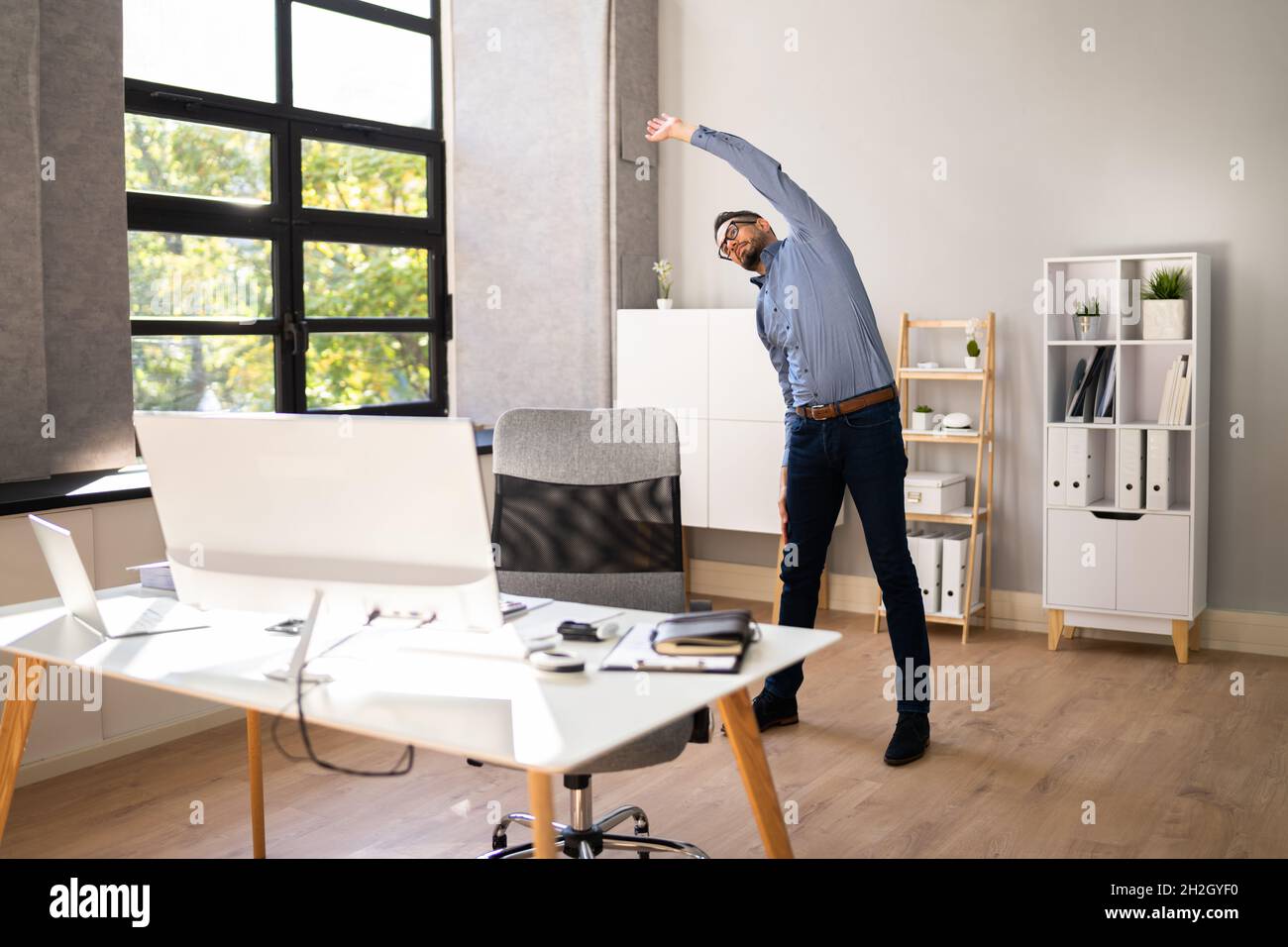 Arms Stretch Exercise Standing In Front Of Computer Stock Photo - Alamy