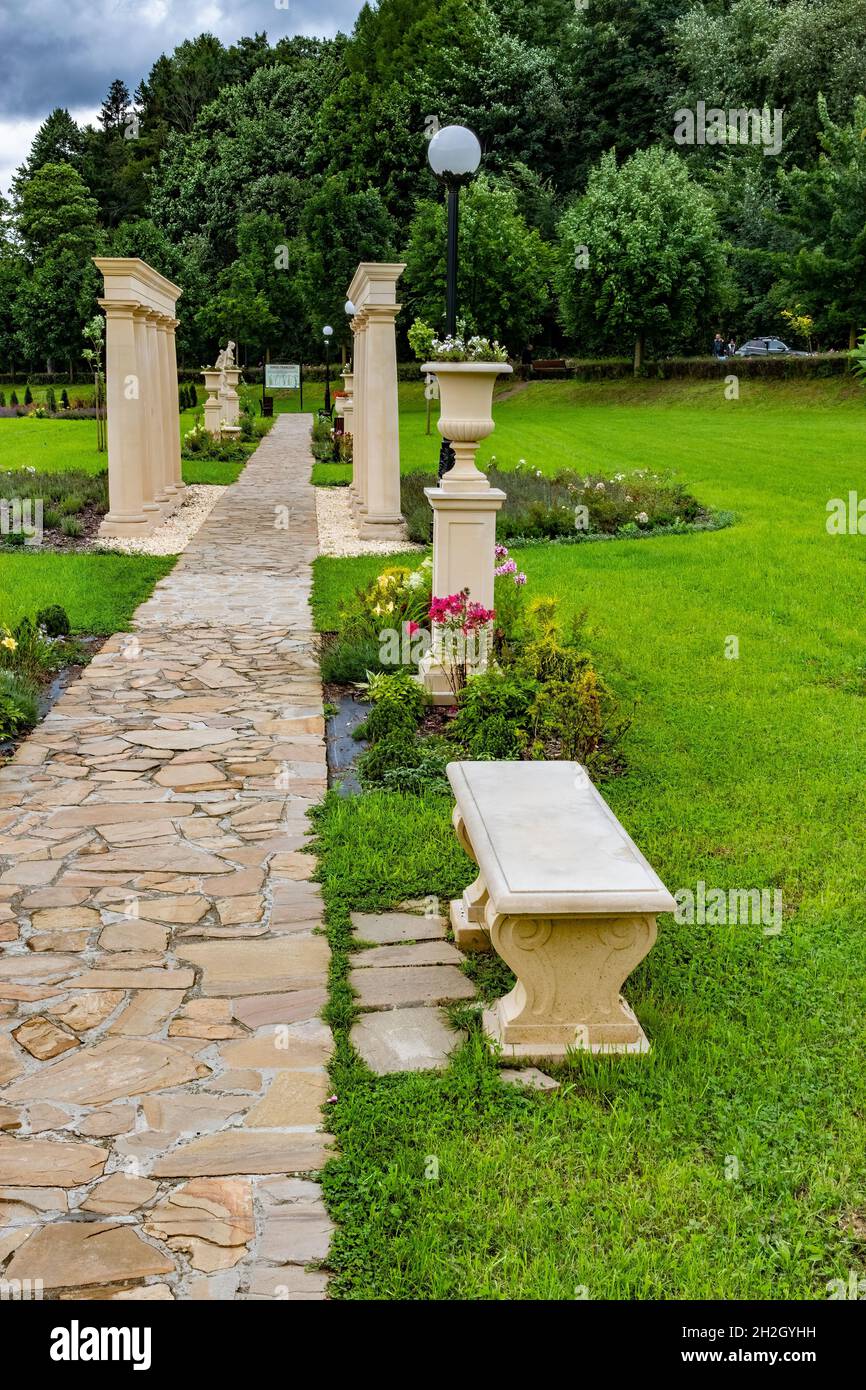 Park with cobblestone walkways and decorative columns Stock Photo - Alamy