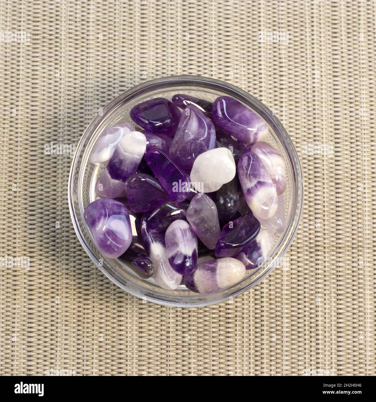 set of various amethyst natural mineral stones and gemstones on glass ...