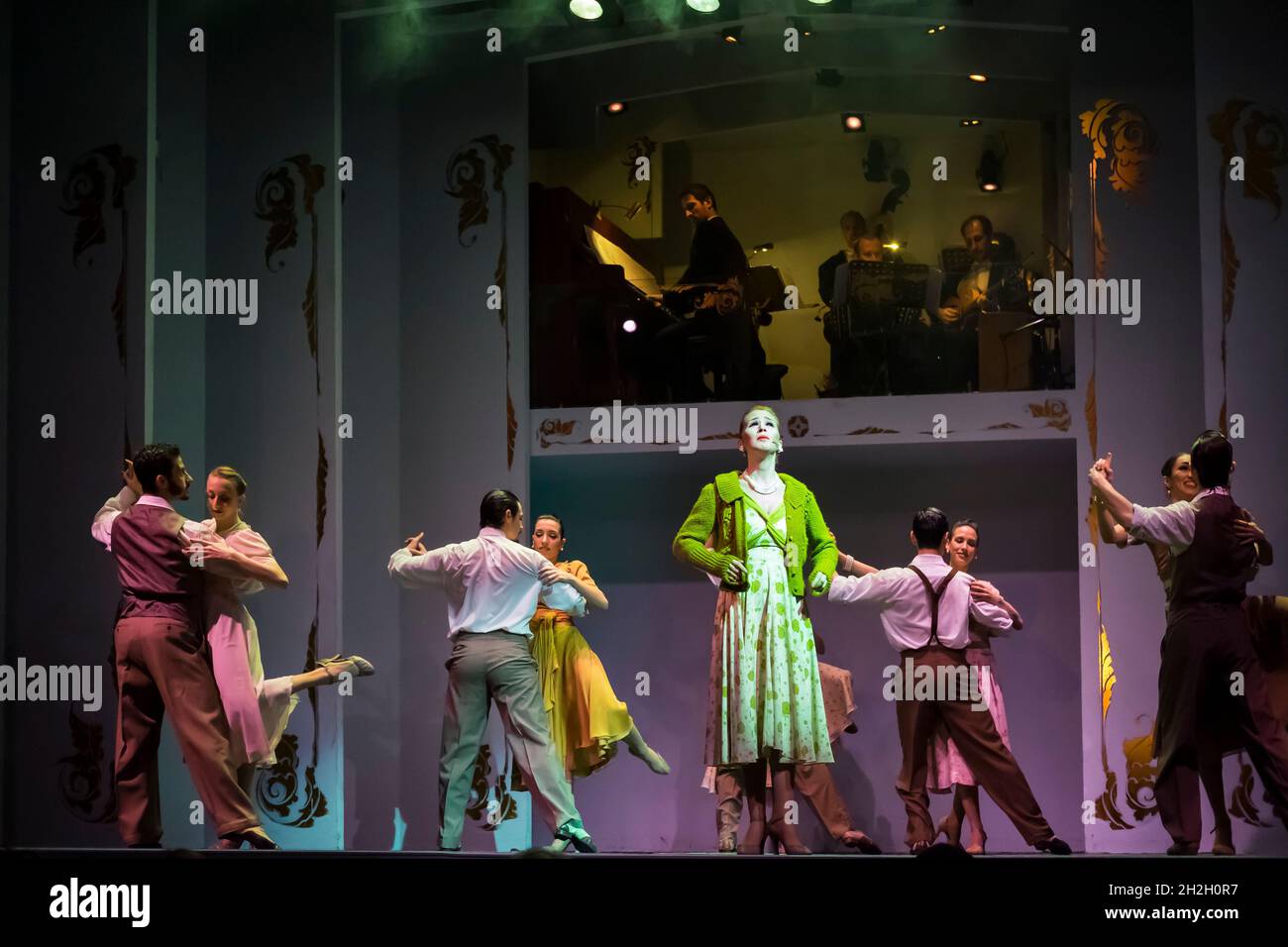 Horizontal shot of a group of dancers and a singer in a tango ...