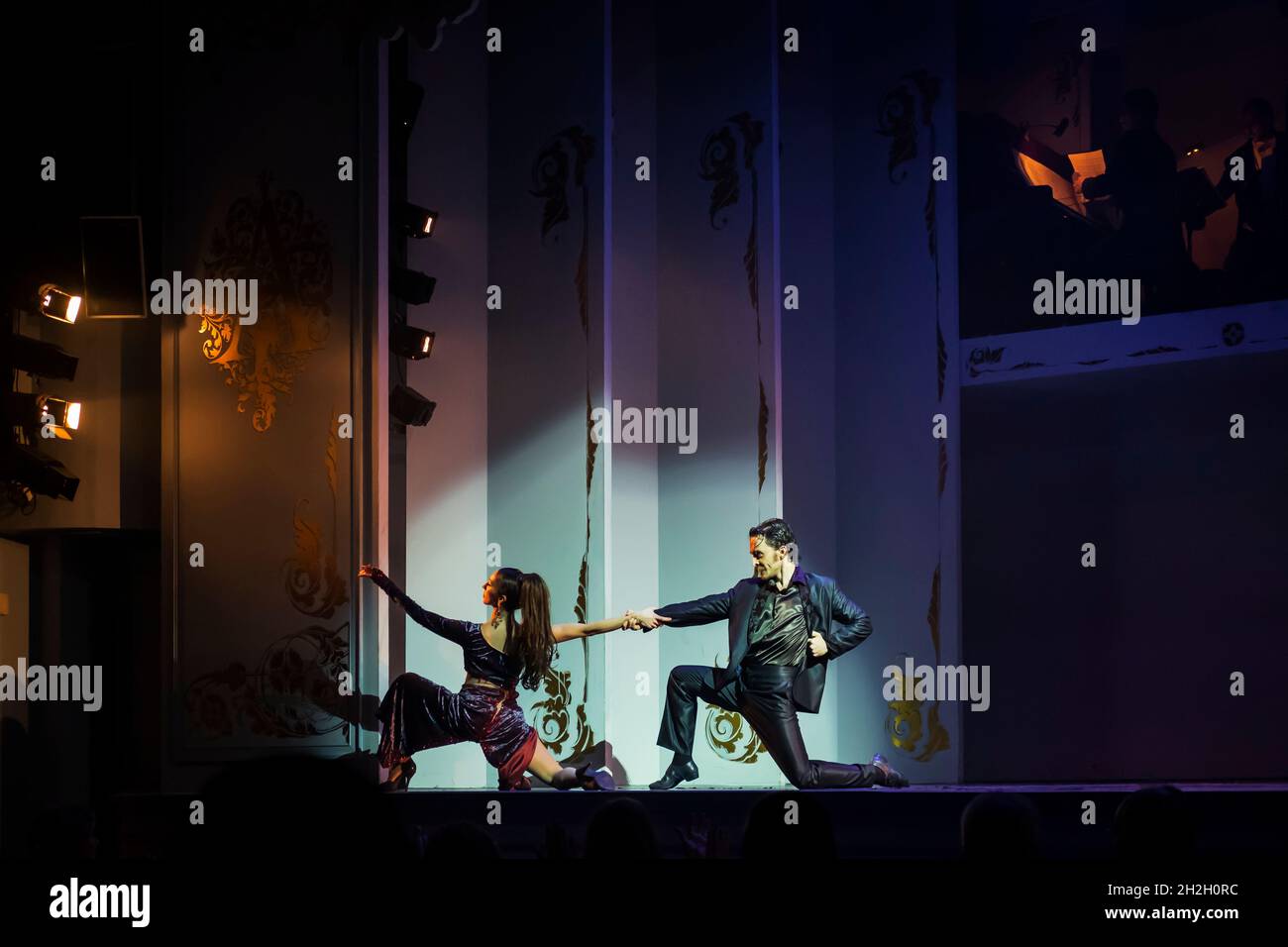 Horizontal shot of a couple of dancers in a tango performance, with ...
