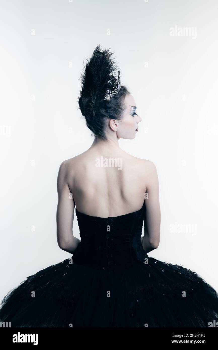 Back view of young ballerina wearing black tutu, stage dress posing ...