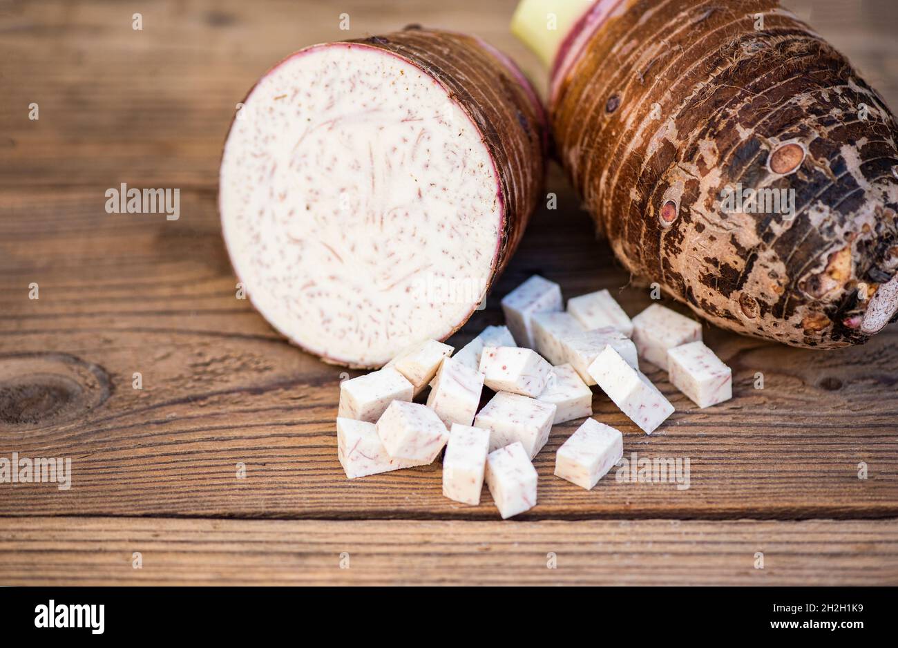 Taro root with half and slice cubes on wooden background, Fresh raw ...