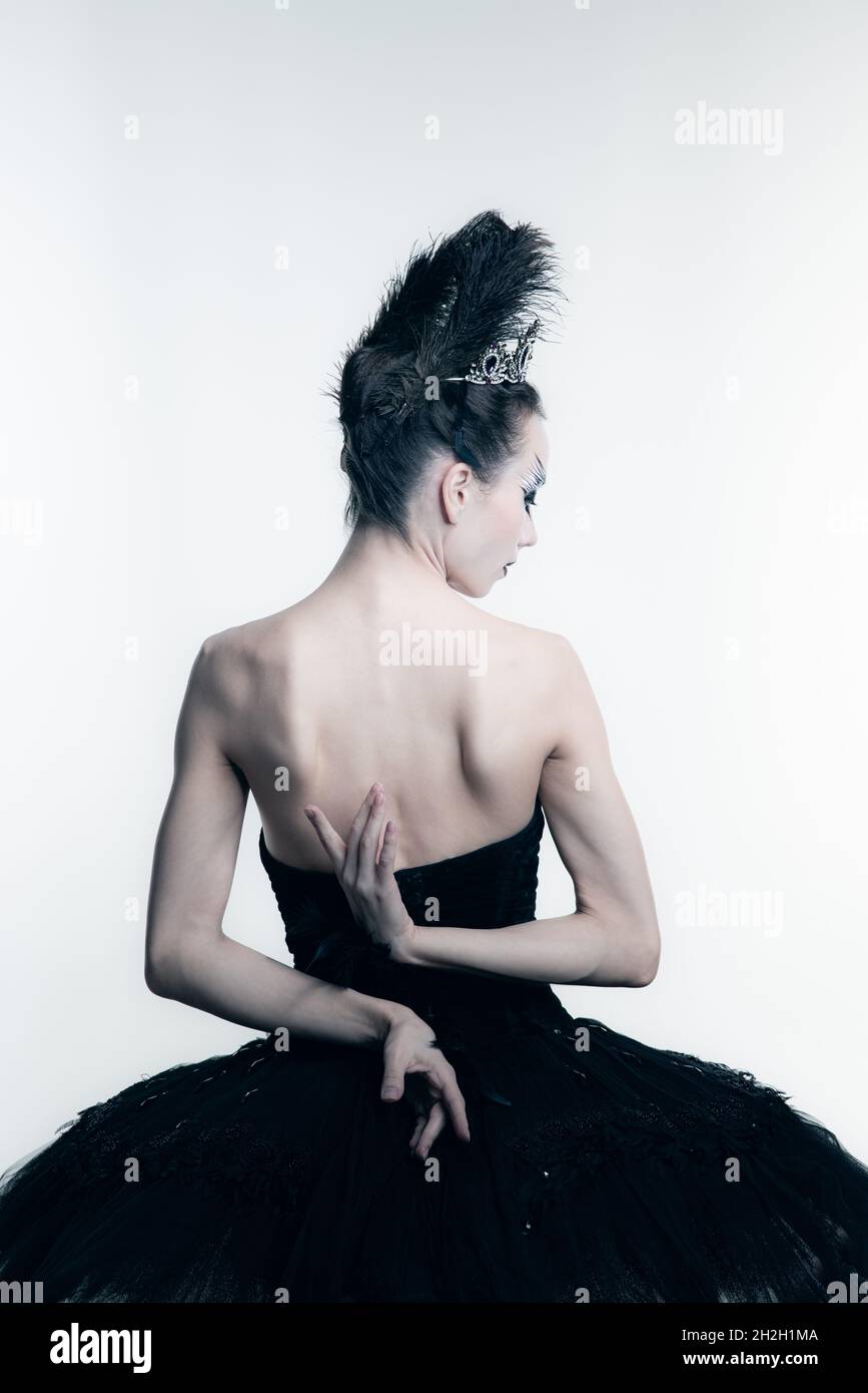 Back view of young ballerina wearing black tutu, stage dress posing ...