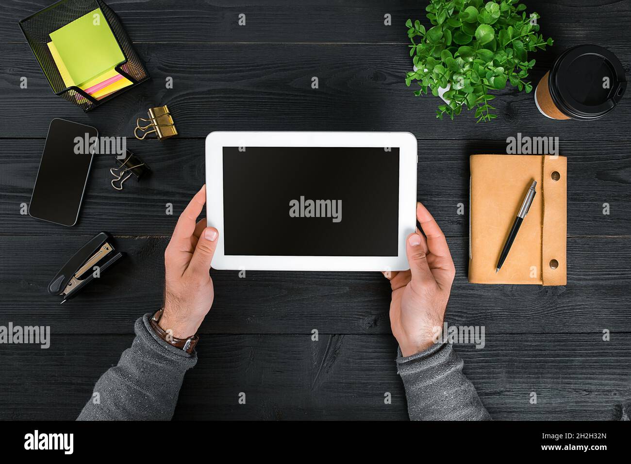 Directly above view of human hands with digital tablet Stock Photo - Alamy