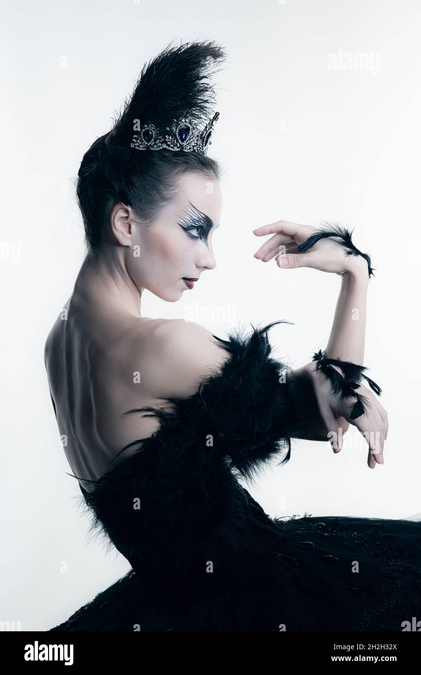 Side view of young ballerina wearing black tutu, stage dress and bright ...