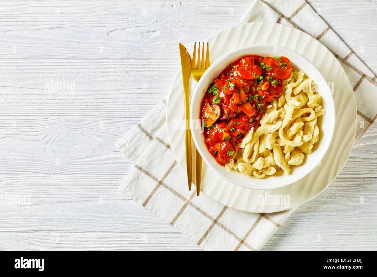 spaetzle with mushroom gravy in a white bowl, jagerspatzle ...