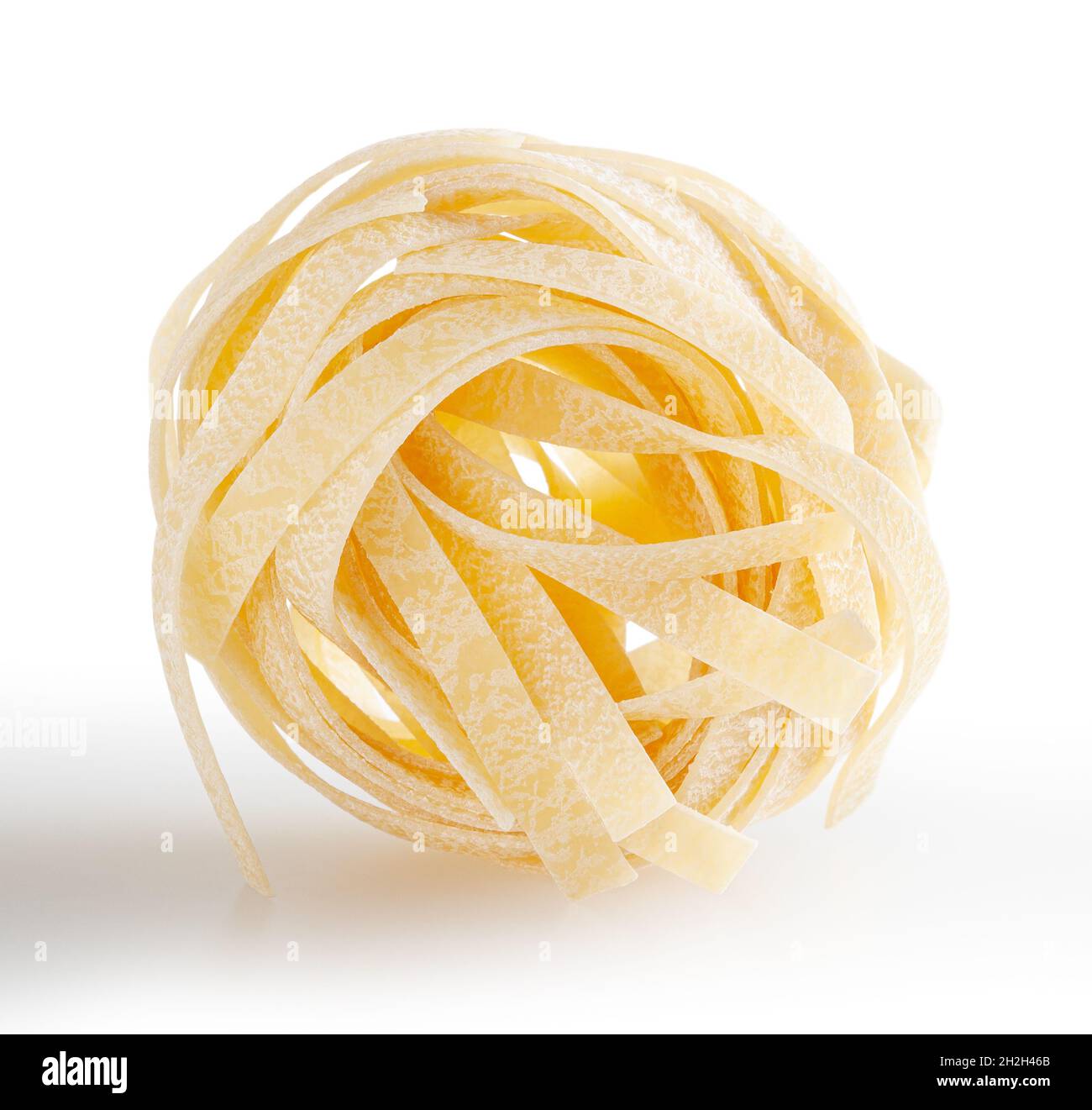 Uncooked tagliatelle pasta isolated on white background with clipping ...