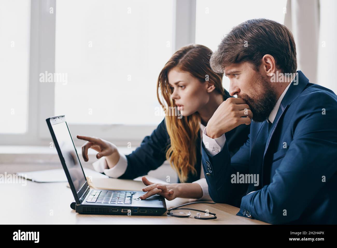 managers in the office in front of a laptop career work technologies ...