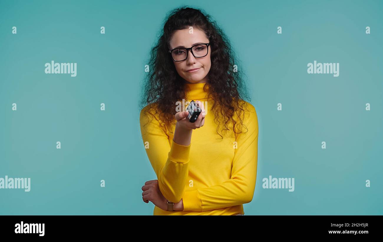 displeased woman with remote controller clicking channels isolated on ...