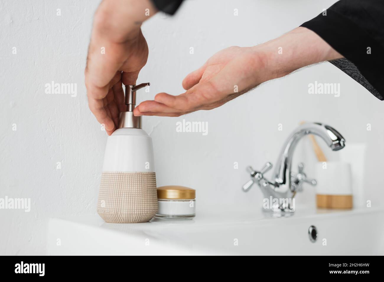 Cropped view of man pouring liquid soap on hand in bathroom Stock Photo ...