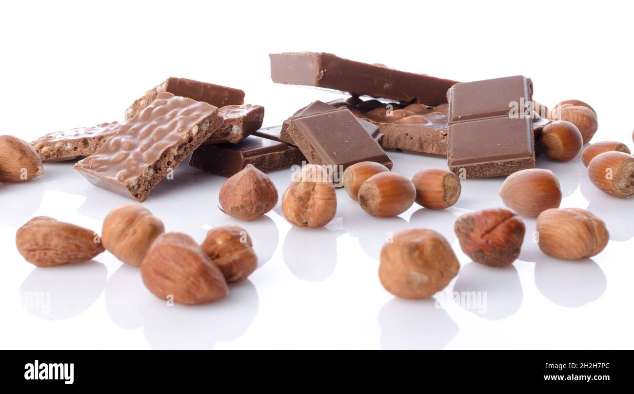 Chocolate with hazelnuts, isolated on white Stock Photo - Alamy