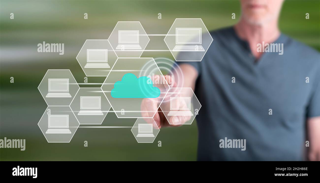 Man touching a cloud computing concept on a touch screen with his ...