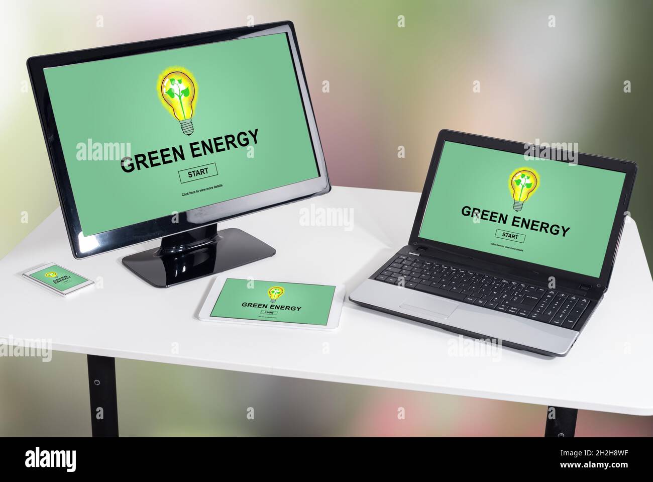 Green energy concept shown on different information technology devices ...