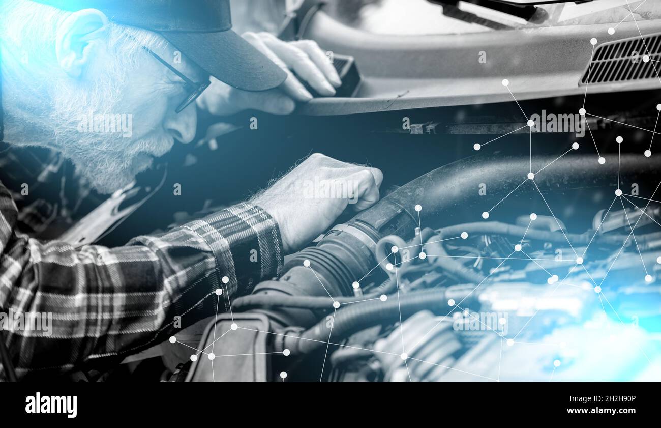 Car mechanic checking a car engine; light effect Stock Photo - Alamy