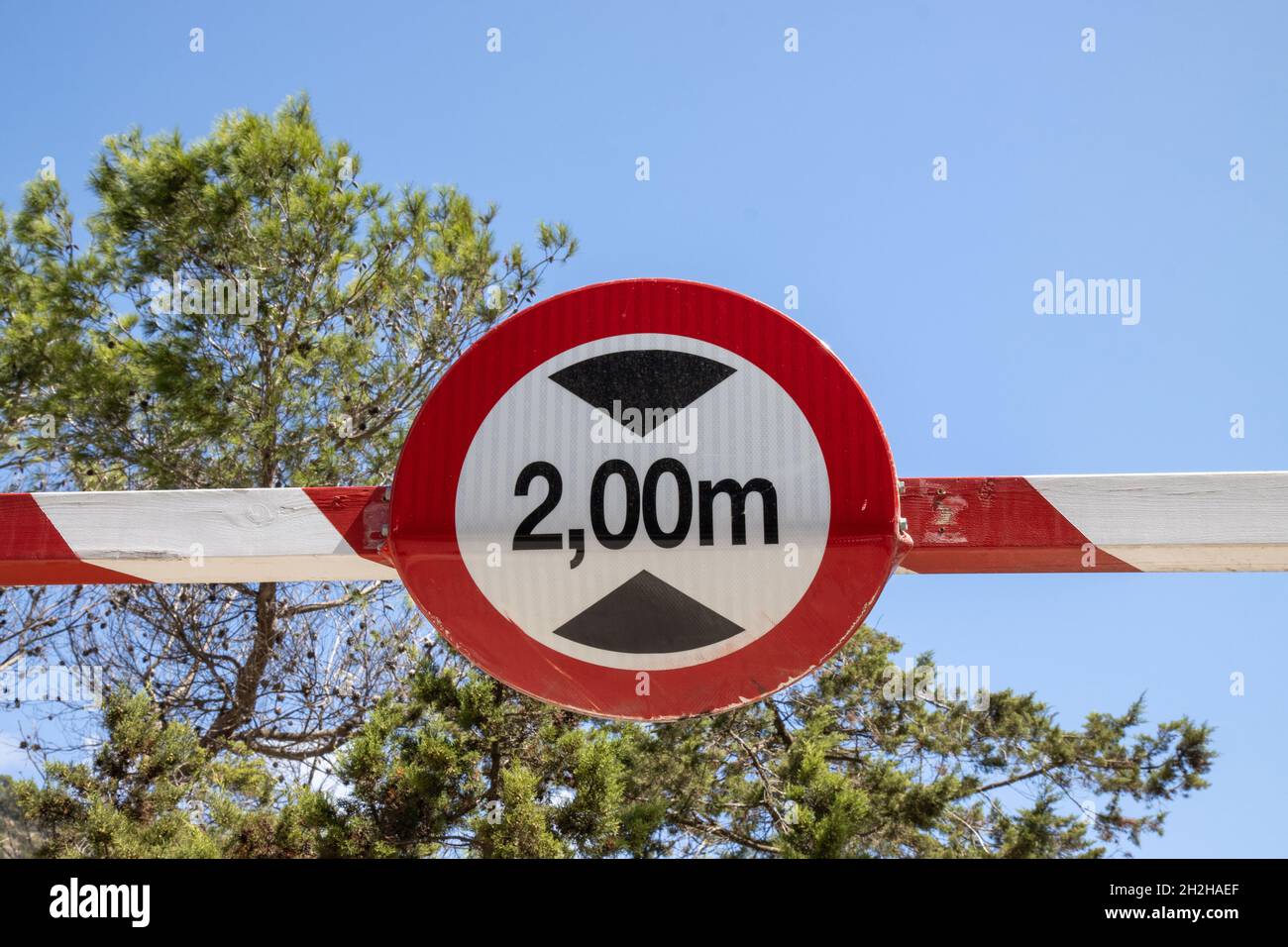 A traffic sign saying 2,00m high that has been hit by a large van in ...