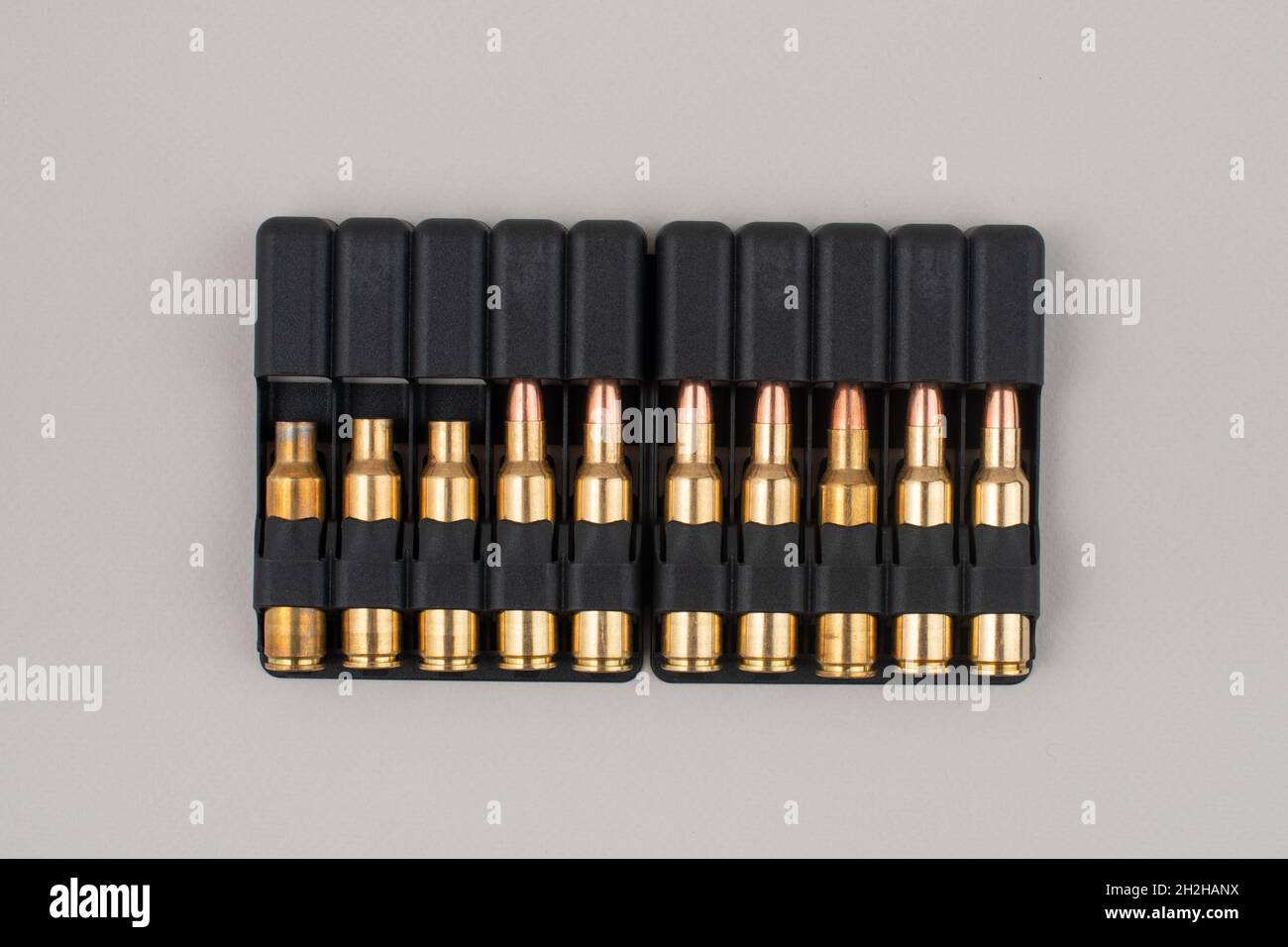 Rifle bullets in plastic cases isolated on grey background Stock Photo ...