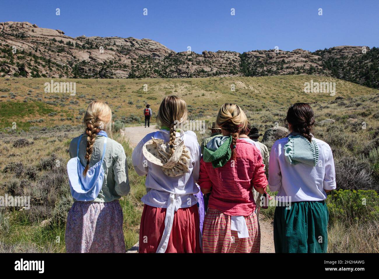 Teenage girls in pioneer drees re-enact a Mormon pioneer handcart trek ...
