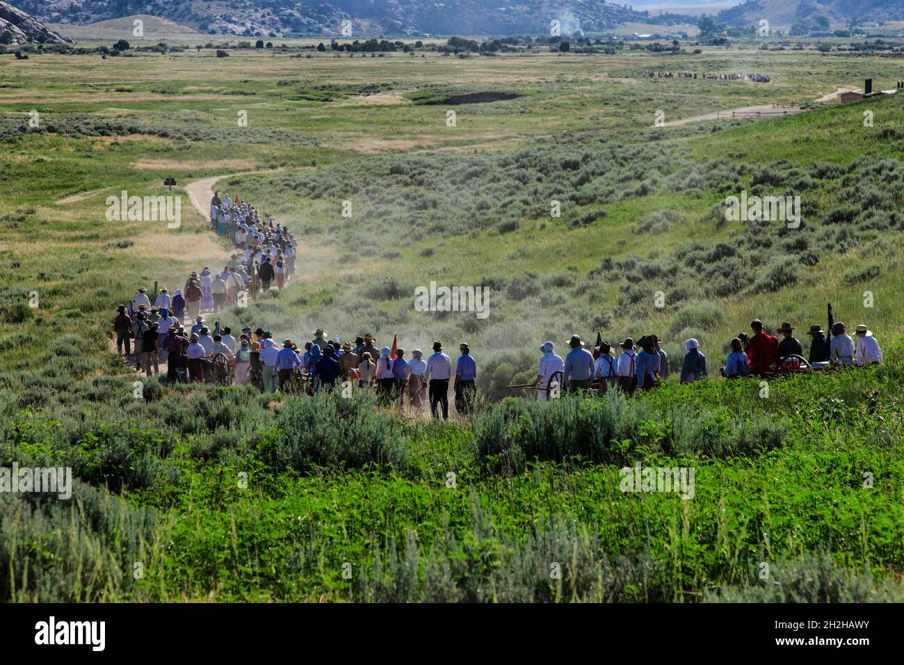A group of teenaged young people re-enact a Mormon pioneer handcart ...