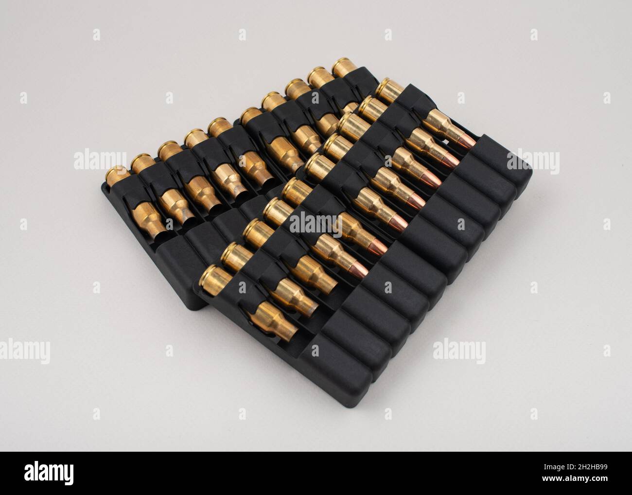 Rifle bullets in plastic cases isolated on grey background Stock Photo ...