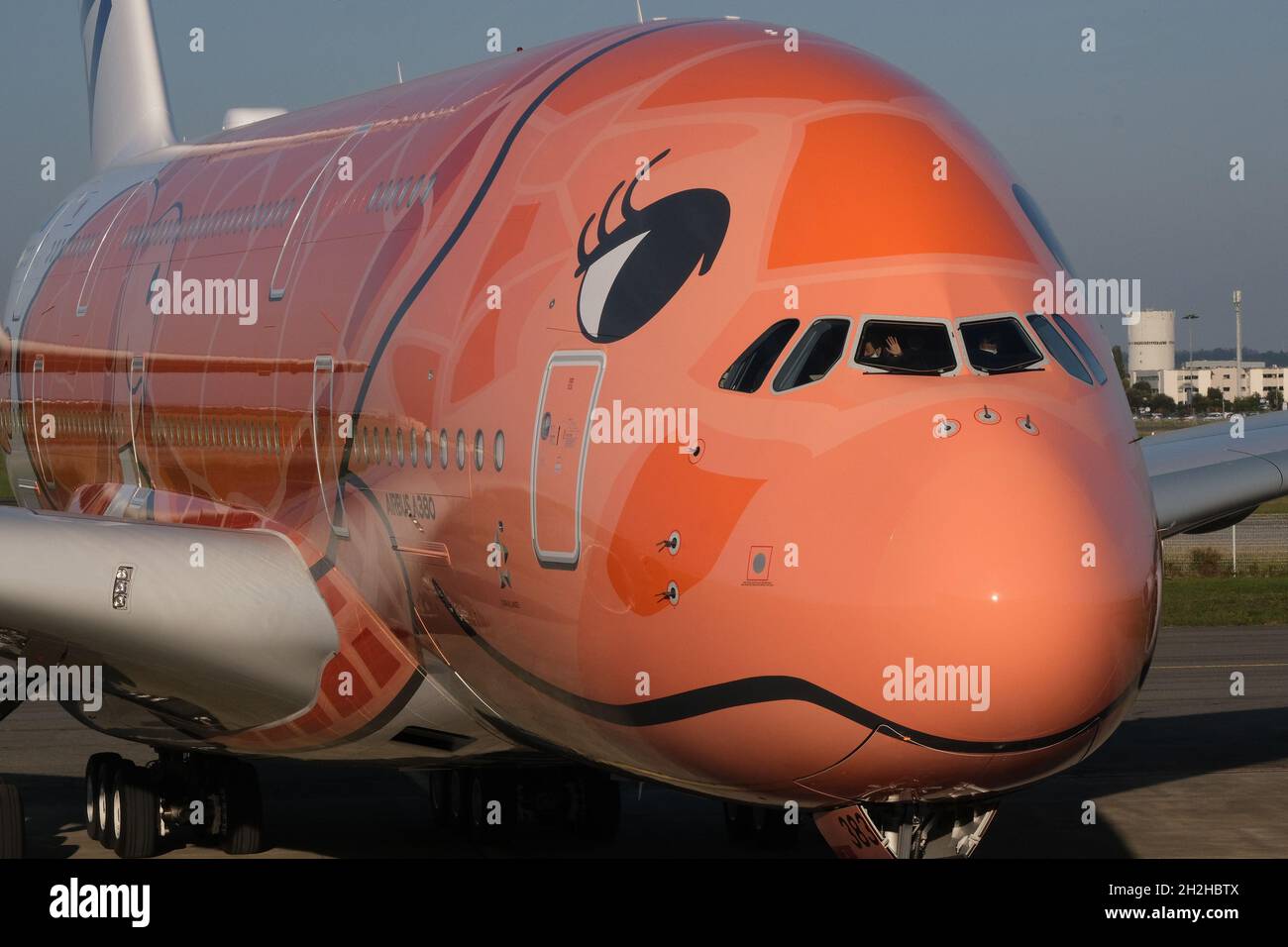 Pilots wave from the cockpit of ANA's the 3rd Airbus A380 (JA383A ...