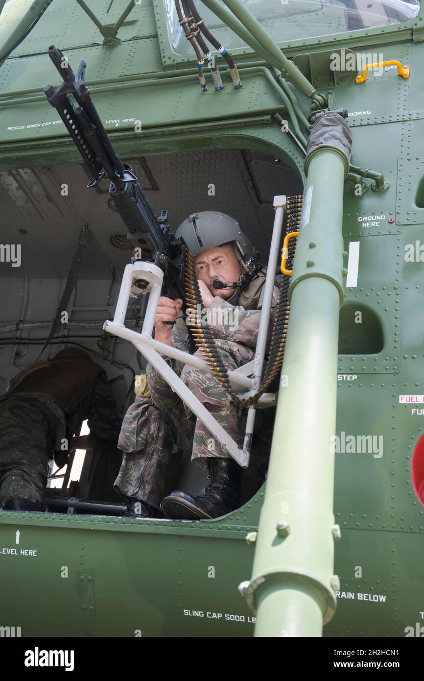 Detail of a soldier with mounted gun on a HMM-361 helicopter. At the ...