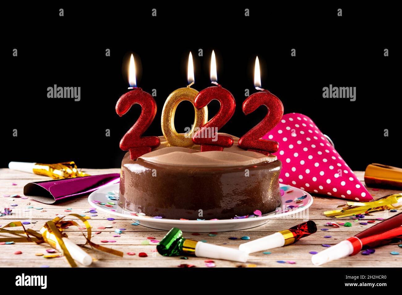 2022 cake and ornaments on wooden table and black background Stock ...