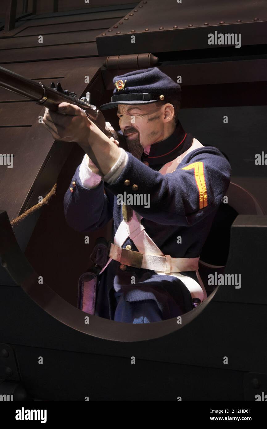 A Colonial era marine in blue uniform shooting from a wood ship. At the ...
