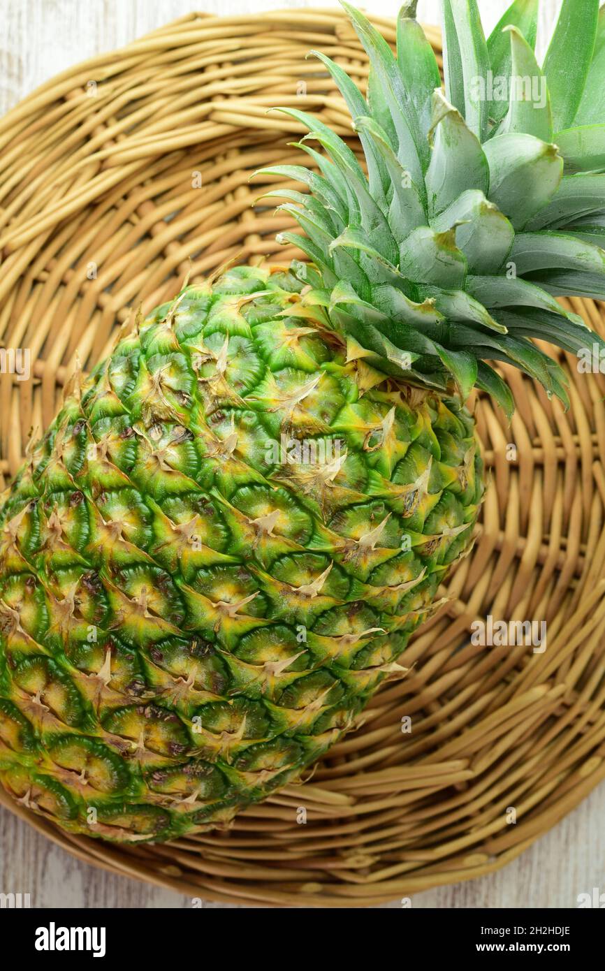Top view of fresh pineapple on a wicker basket Stock Photo - Alamy