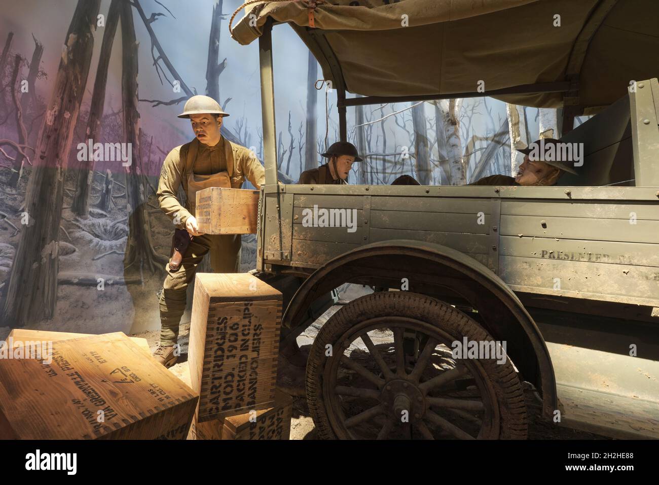 A soldier unloading wood boxes, crates from a truck during WWI. At the ...