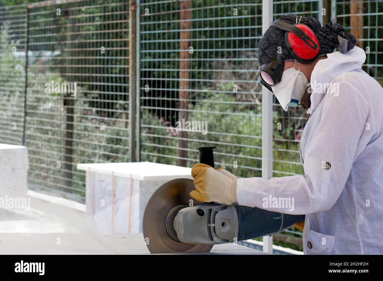 sculptor cuts marble with machine Stock Photo - Alamy