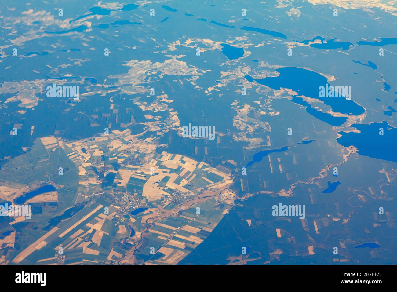 Aerial view of landscape terrain . Fields and lakes view from airplane ...