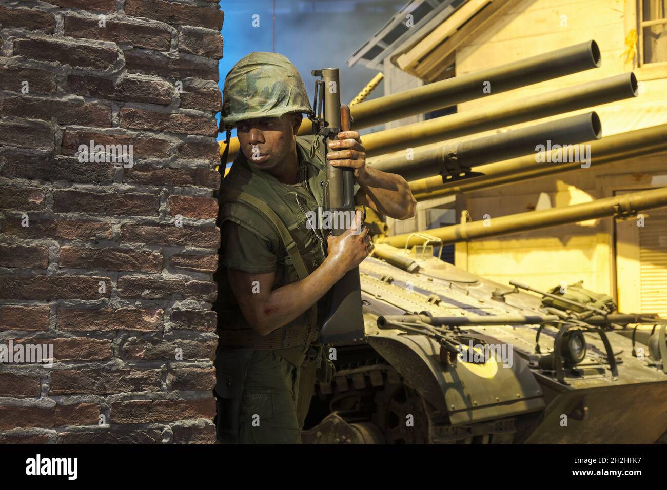A soldier on guard in front of a Rifle Multiple 106mm Self-propelled ...